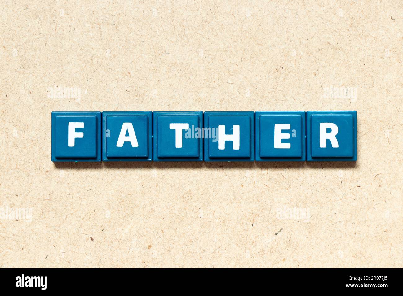 Tile alphabet letter in word father on wood background Stock Photo - Alamy