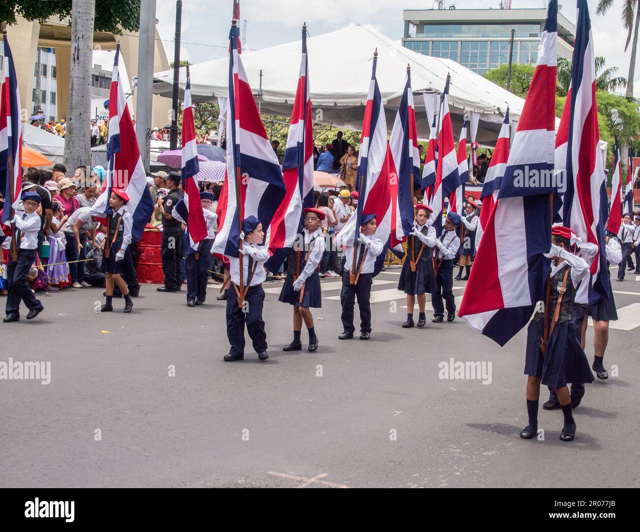 Young people marching holding the Costa Rican flag in the Independence ...