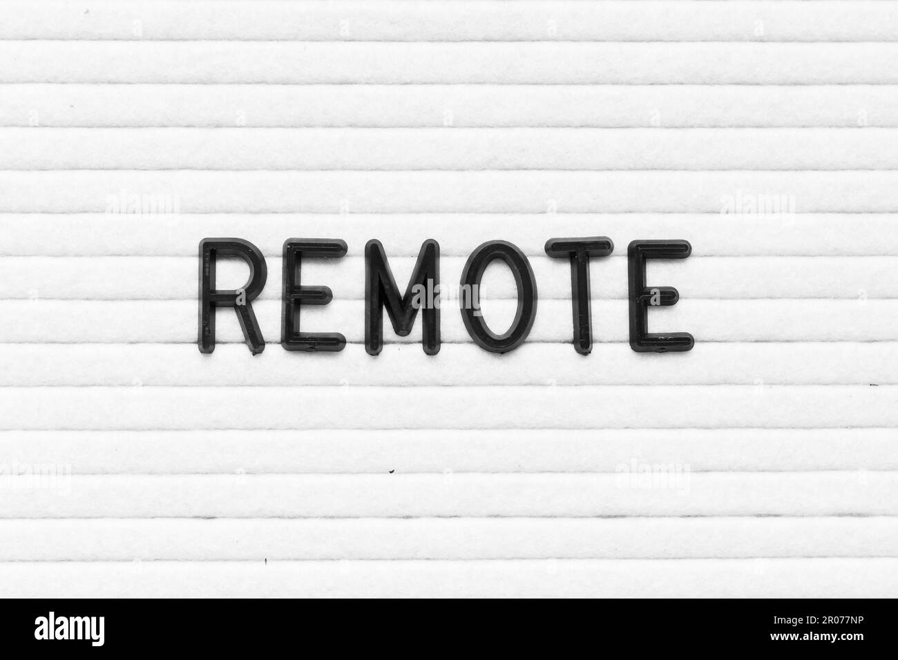Black color letter in word remote on white felt board background Stock ...