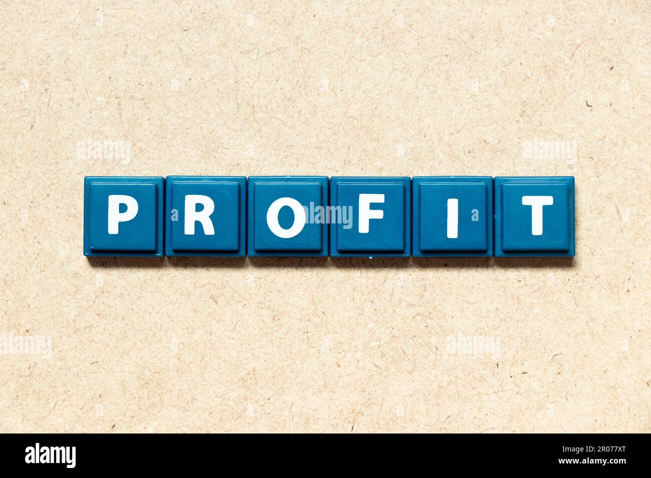 Tile alphabet letter in word profit on wood background Stock Photo - Alamy