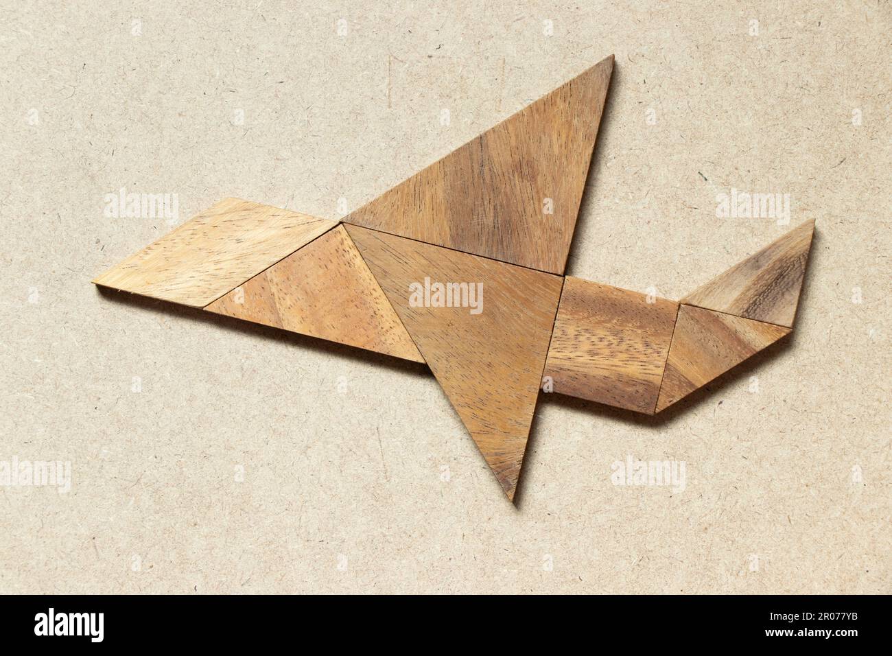 Wooden tangram in flying plane shape on wood background Stock Photo - Alamy
