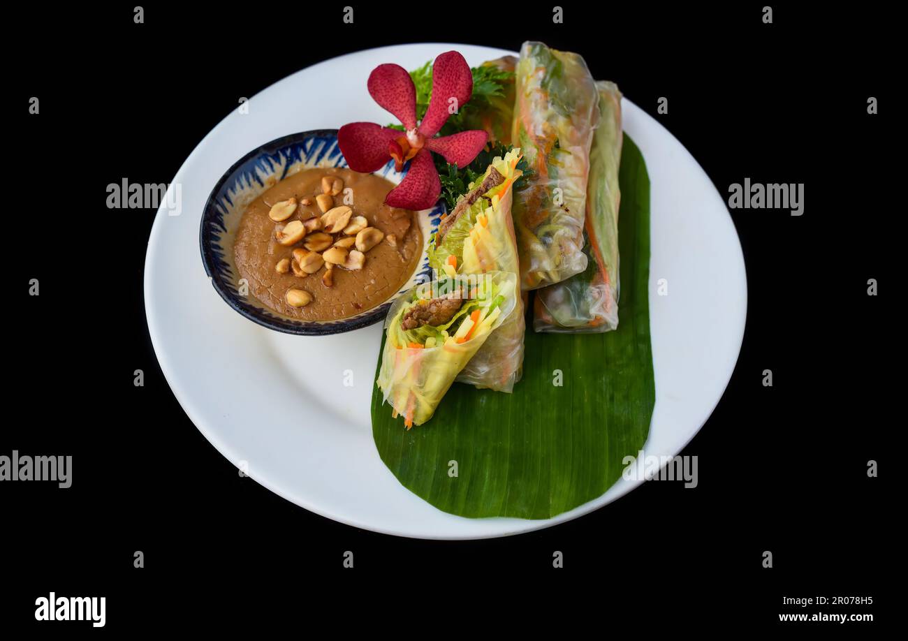Vietnamese nem spring rolls in leaf with sauce Stock Photo - Alamy