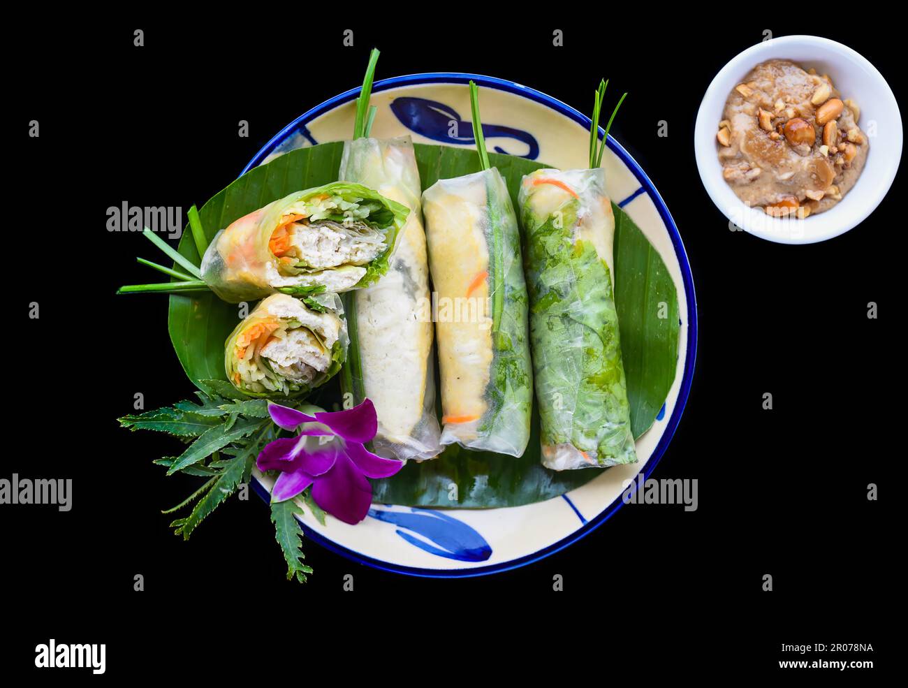 Vietnamese nem spring rolls in leaf with sauce Stock Photo - Alamy