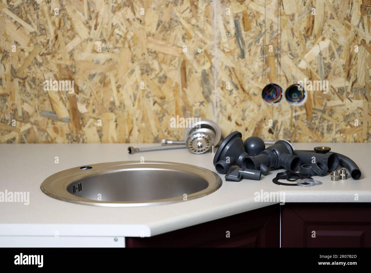 Plumbers tools and water tap ready for installation near sink on ...