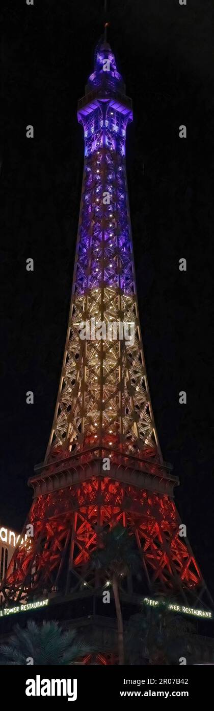 Night view of the Eiffel Tower of the Paris Las Vegas Hotel and Casino lit up in red, white, and ...