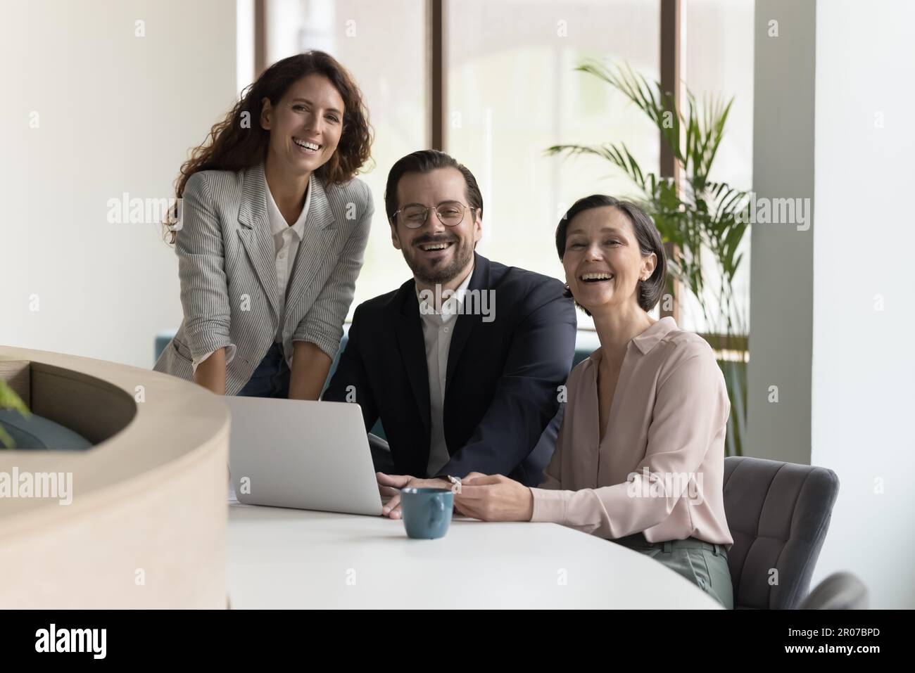 Three diverse office employees posing smile staring at camera Stock ...
