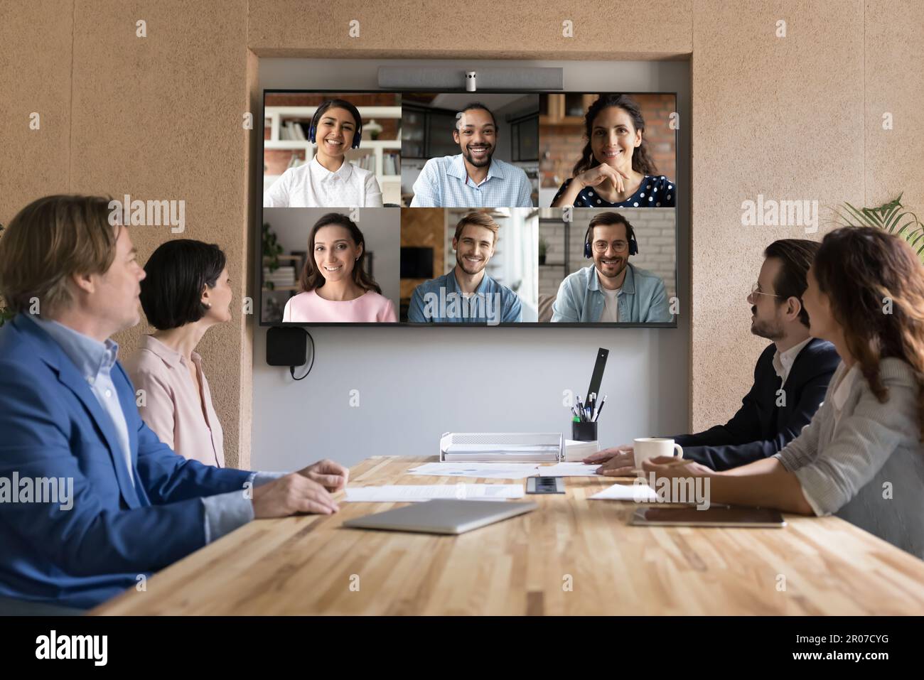 Multiethnic applicants on TV screen during group job interview event ...