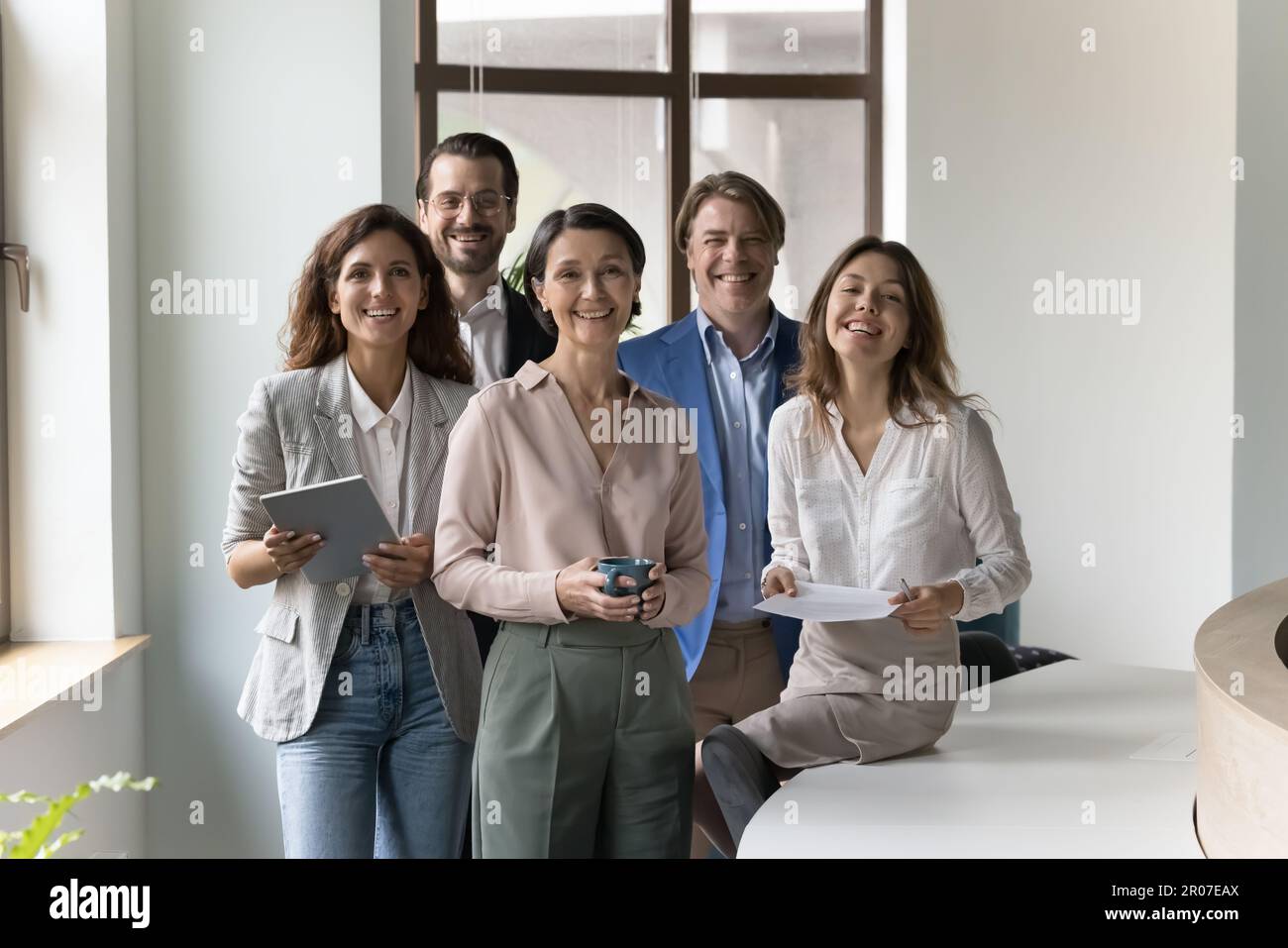 Portrait of modern business startup team members pose at workplace ...