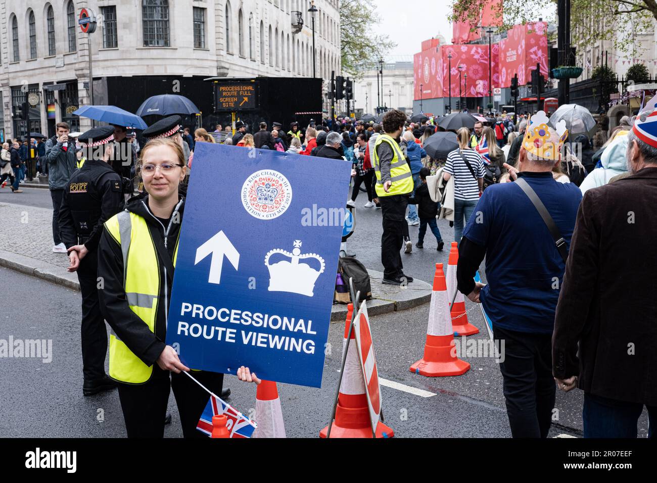 An event staff member seen holding a sign with direction to viewing ...