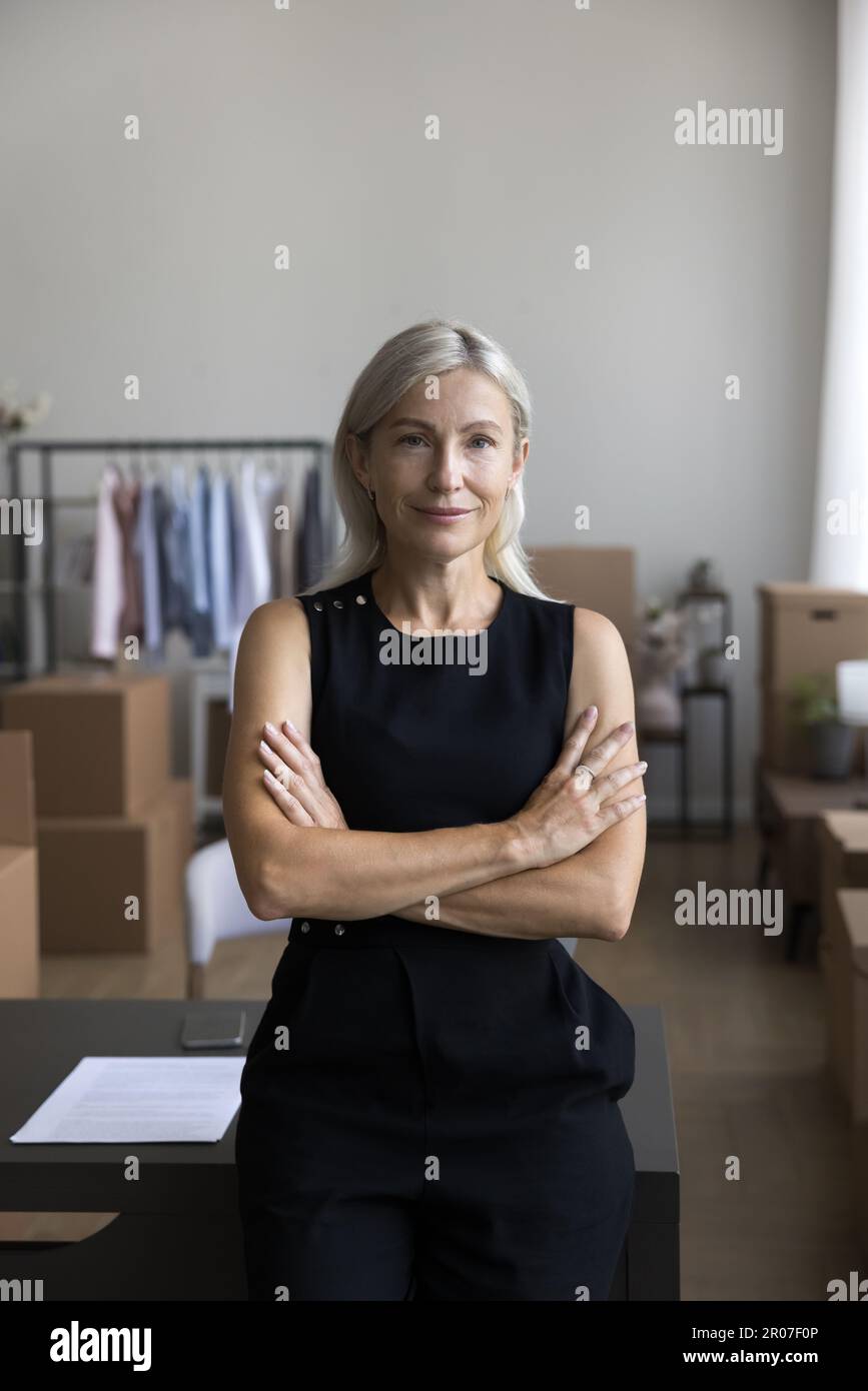 Positive confident middle aged small business owner vertical portrait ...