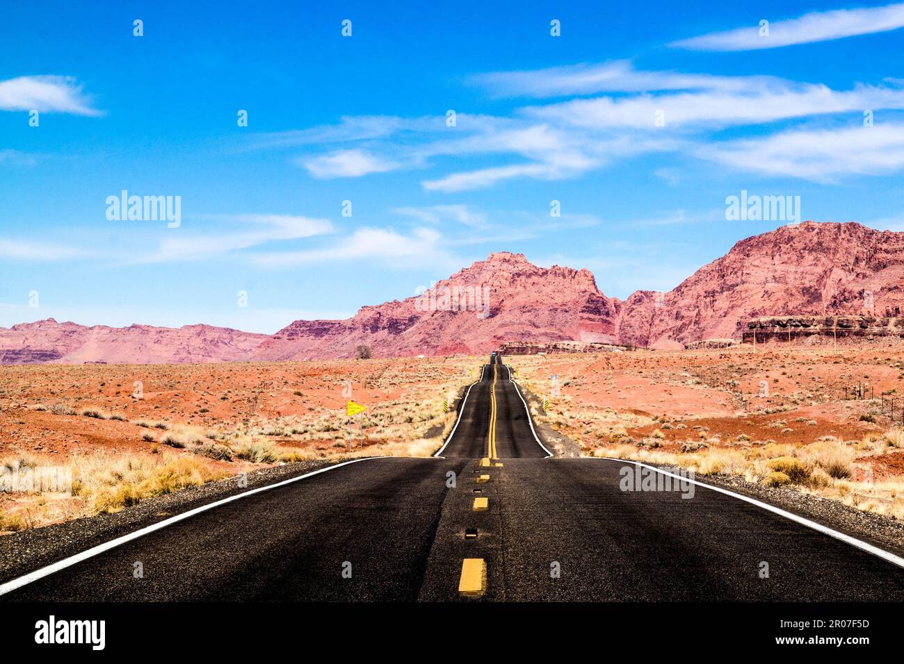 A highway cutting through picturesque mountains in the Western areas of ...