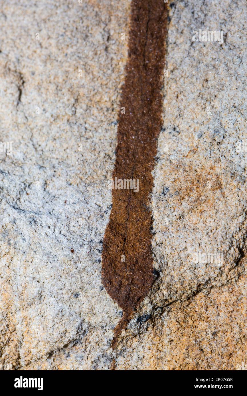 A closeup of a rock formation with red stains Stock Photo - Alamy