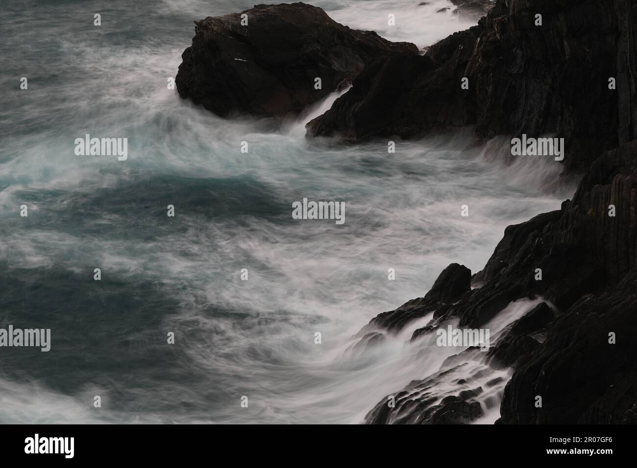 Long exposure of waves crashing on rocks – coastal seascape from Cinque ...