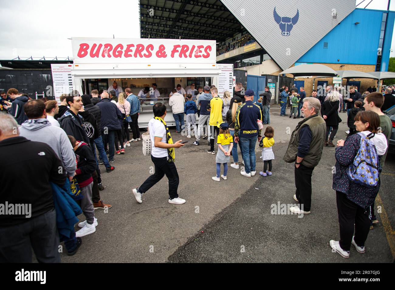 General view of supporters queuing for a burger van outside the ground ...