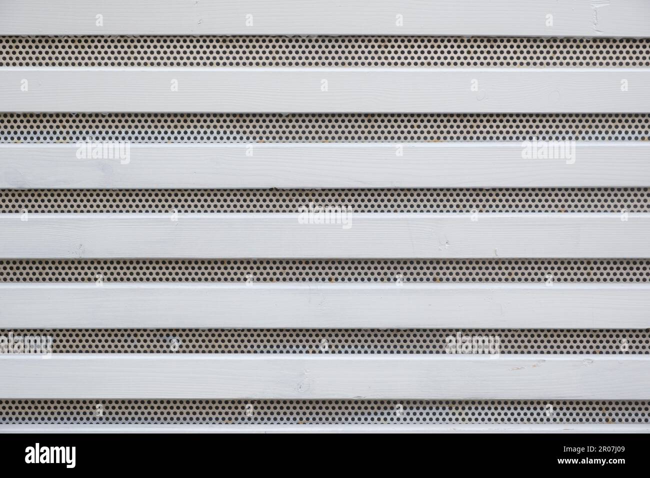 Background, Wall With Perforated Sheet And Boards Stock Photo - Alamy