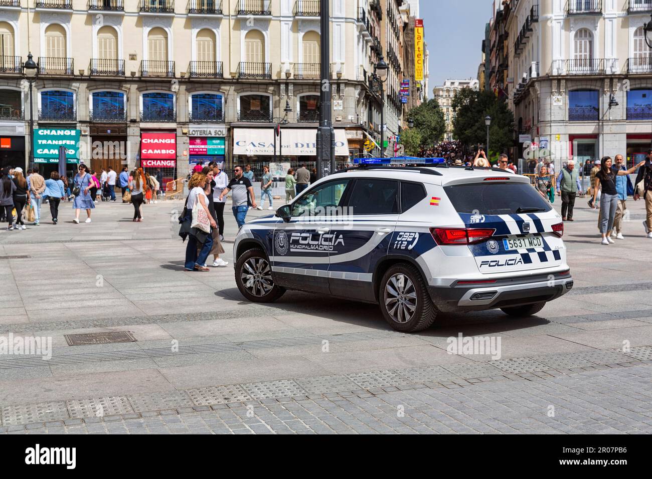 Police car and crowd in the city centre, Plaza Puerta del Sol, Madrid ...