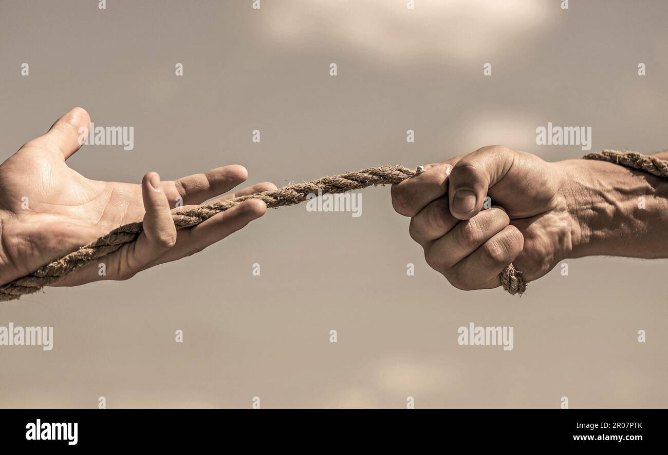 Rescue, help, helping gesture or hands. Conflict tug war. Rope, cord. Hand holding a rope ...