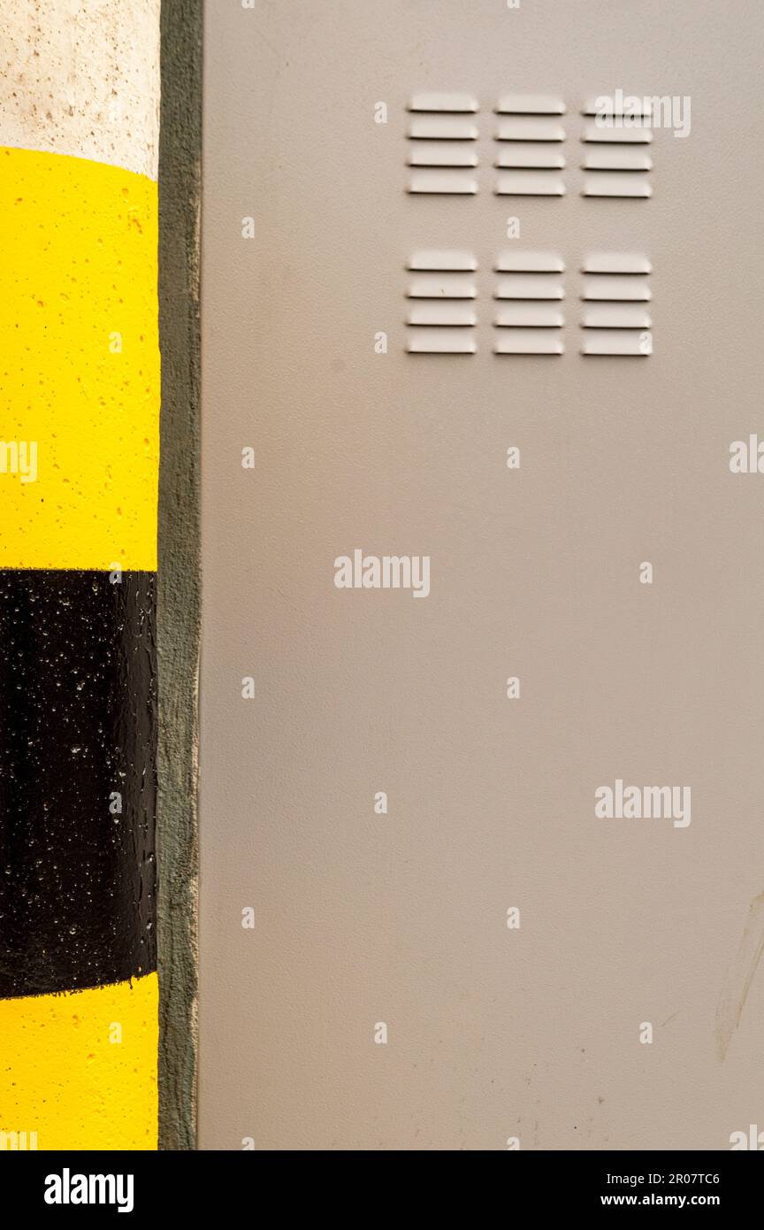 Warning. Electric power box next to a black, yellow and white colored ...