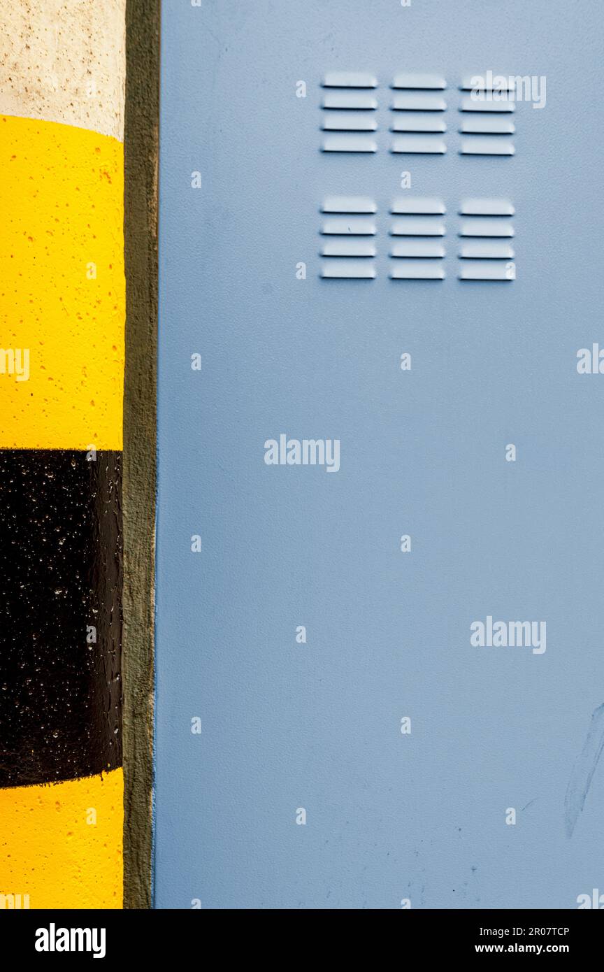 Warning. Electric power box next to a black, yellow and white colored ...