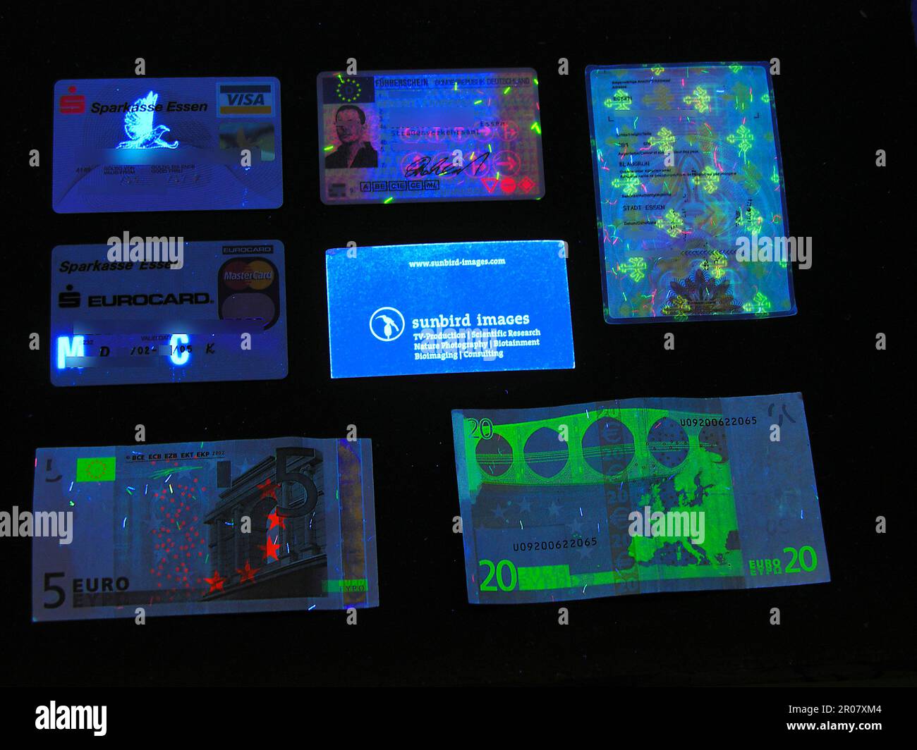 Fluorescent banknotes and identity cards Stock Photo - Alamy