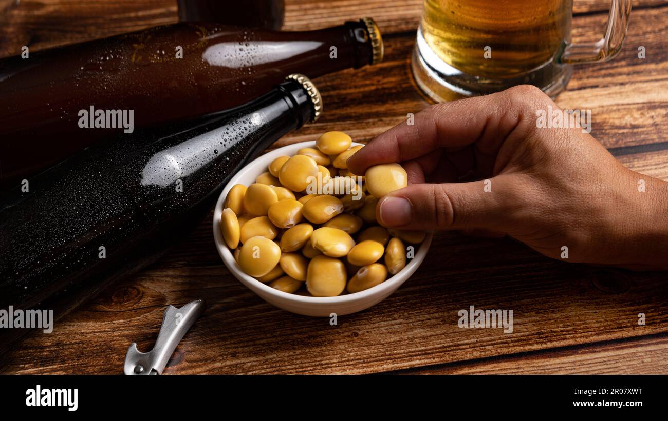 Salted Lupin Beans with beer on table Stock Photo - Alamy