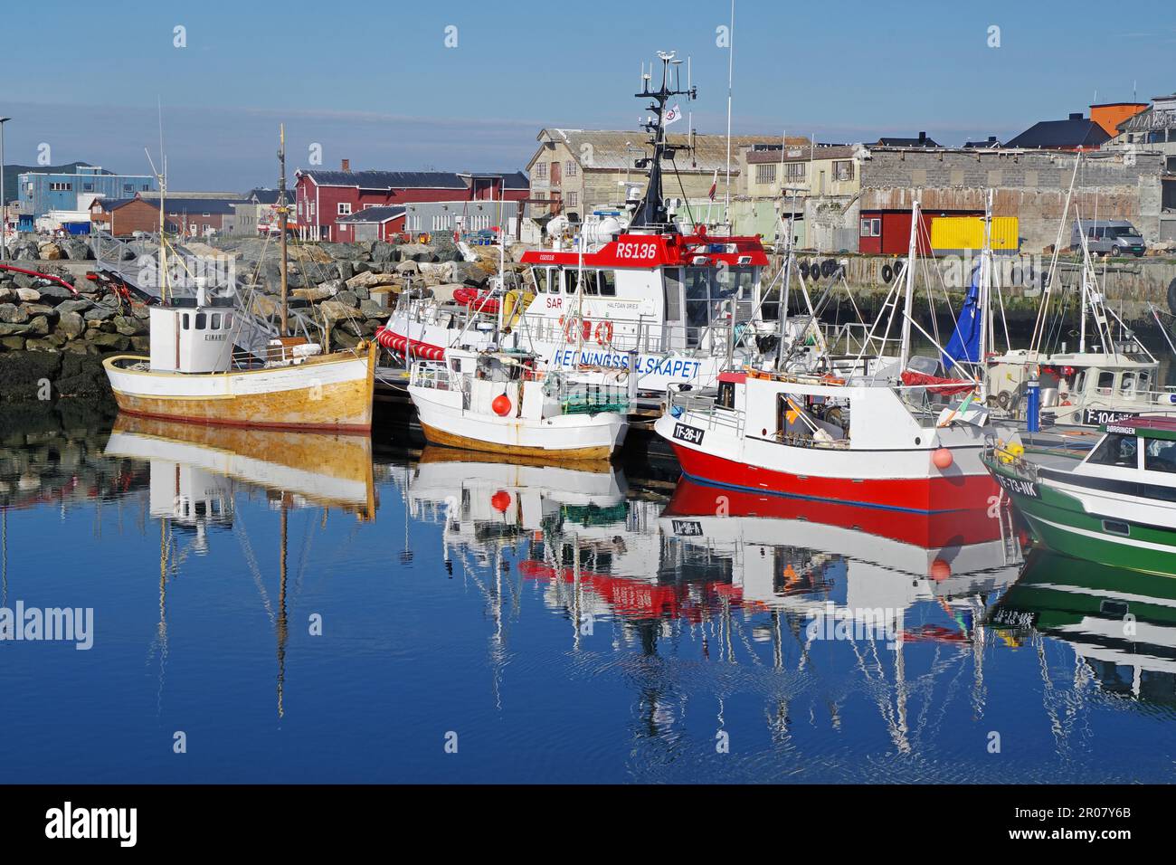 Fishing boats reflected in the smooth water of a harbour basin, Ice Sea ...