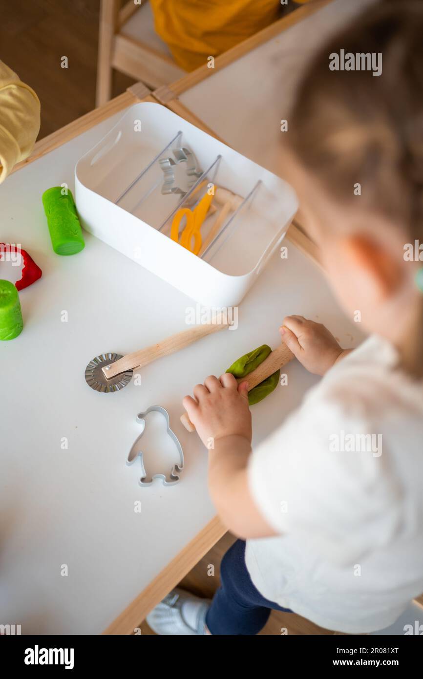 A little girl playing with plasticine. Sensory development and ...