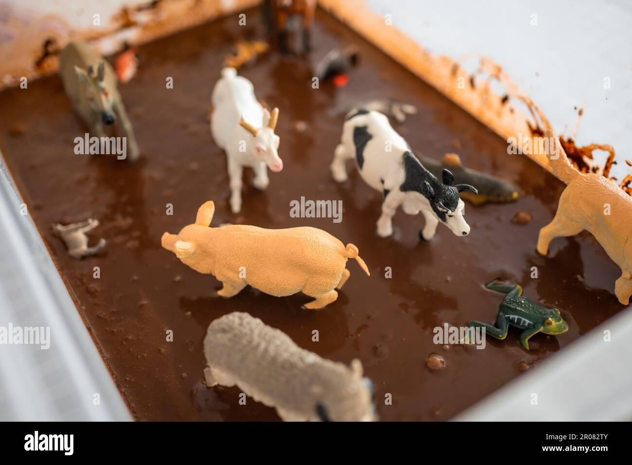 Homemade chocolate sensory mud with farm animal models. Sensory ...