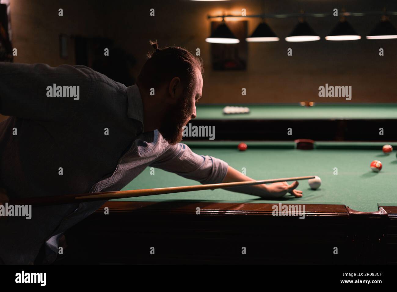 Fragment of the pool billiard game in process. Handsome man playing ...