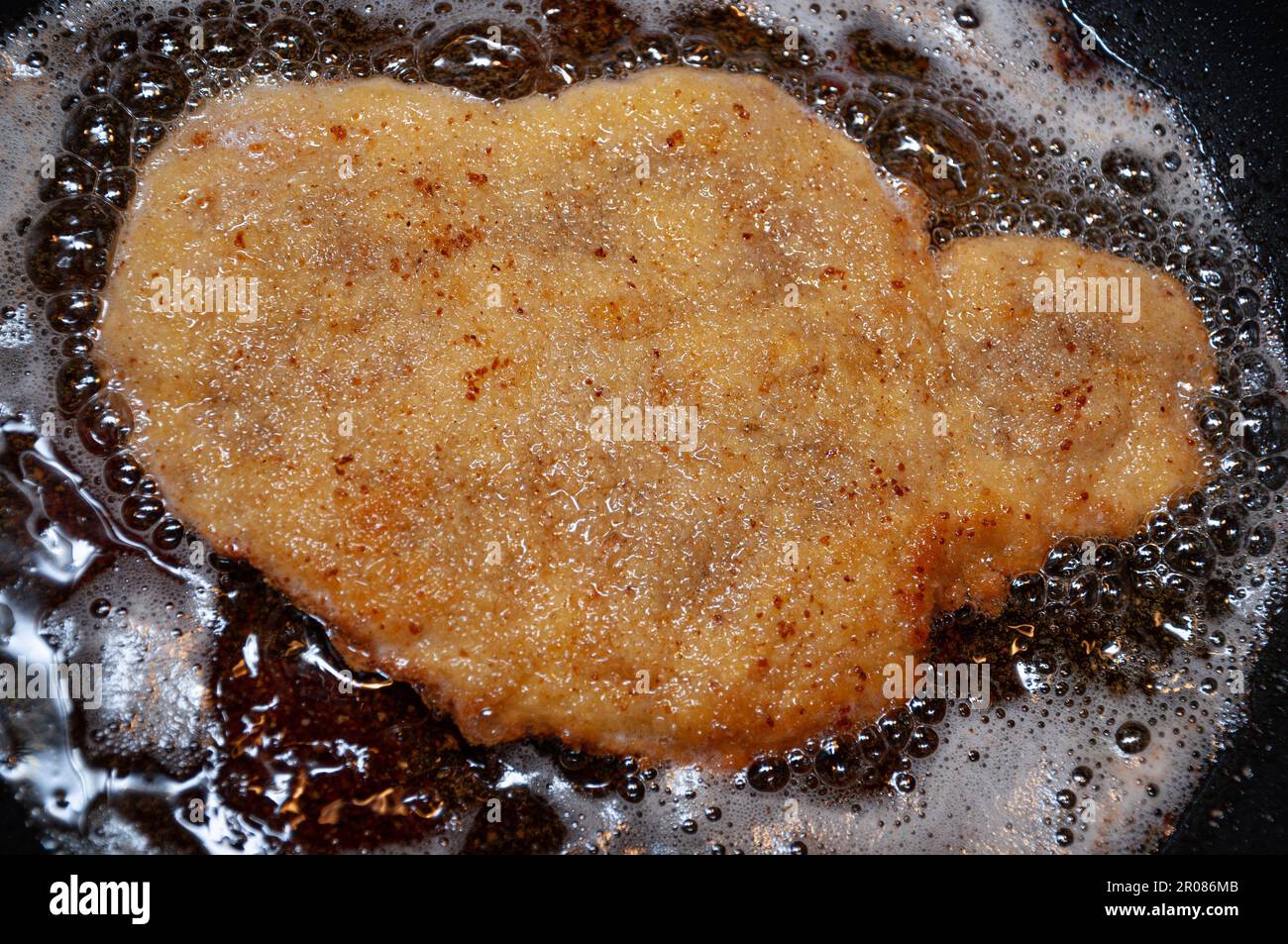 Traditional polish meal. Juicy pork chop fried in a pan. Top view Stock ...