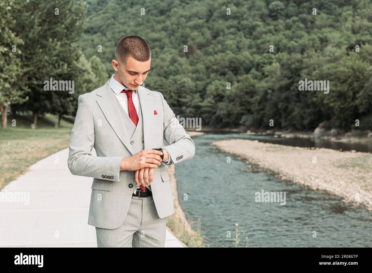 Young teenage boy looking at his watch. Ready for a prom night Stock ...