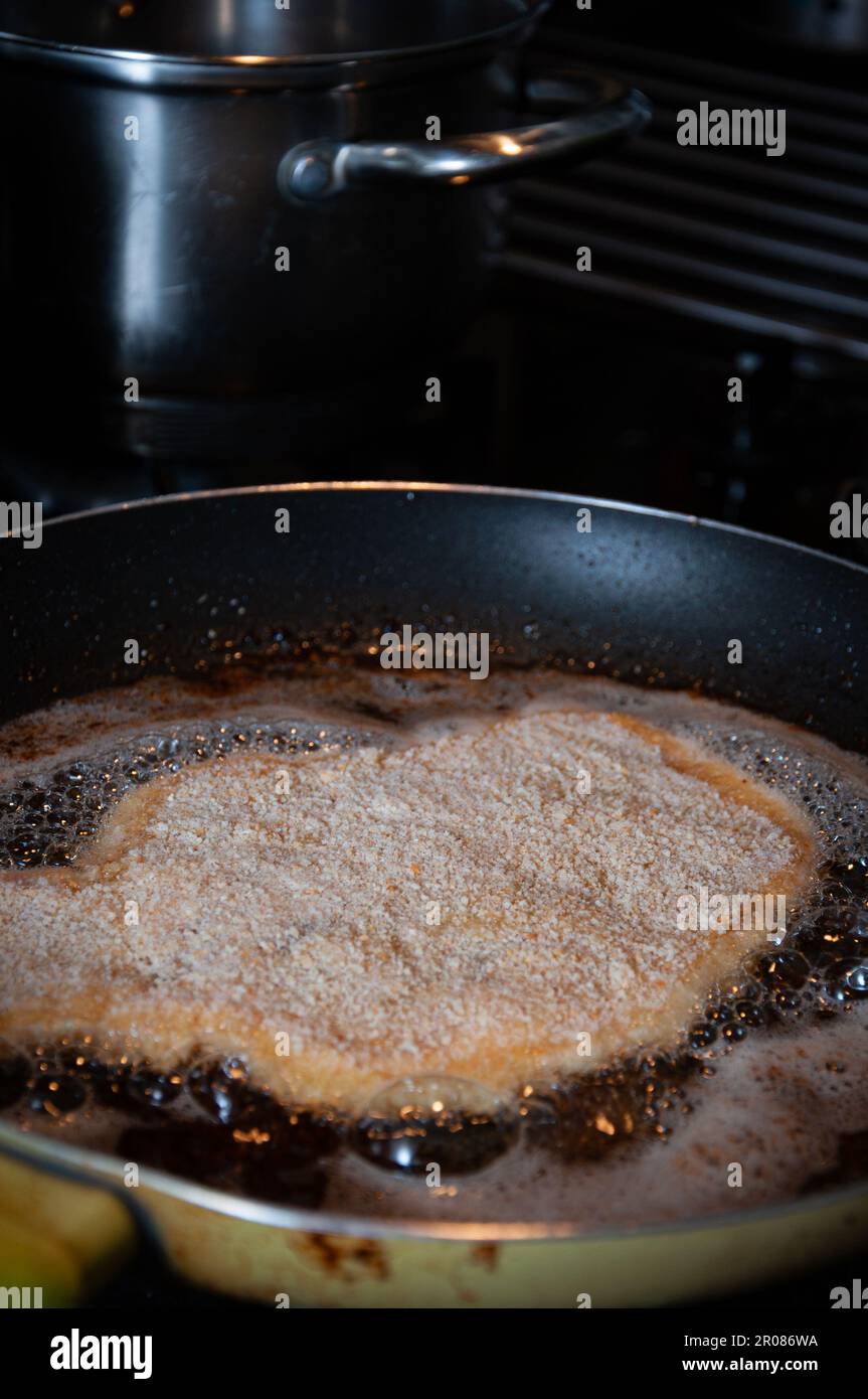 Traditional polish meal. Juicy pork chop fried in a pan. Raw Stock ...