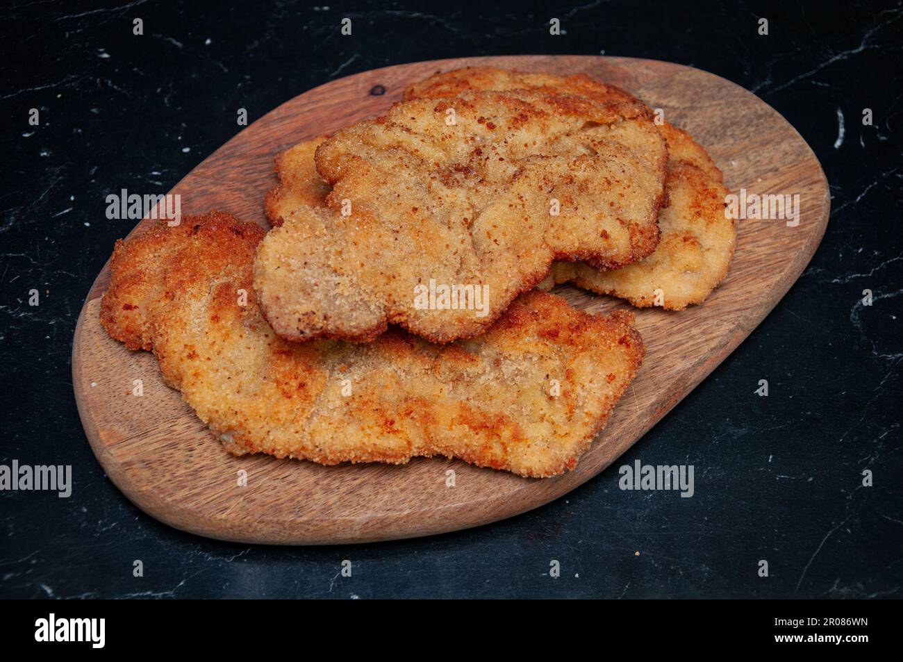 Traditional polish meal. Juicy pork chop pile on a wooden board Stock ...