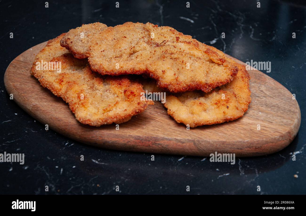 Traditional polish meal. Juicy pork chop pile on a wooden board Stock ...