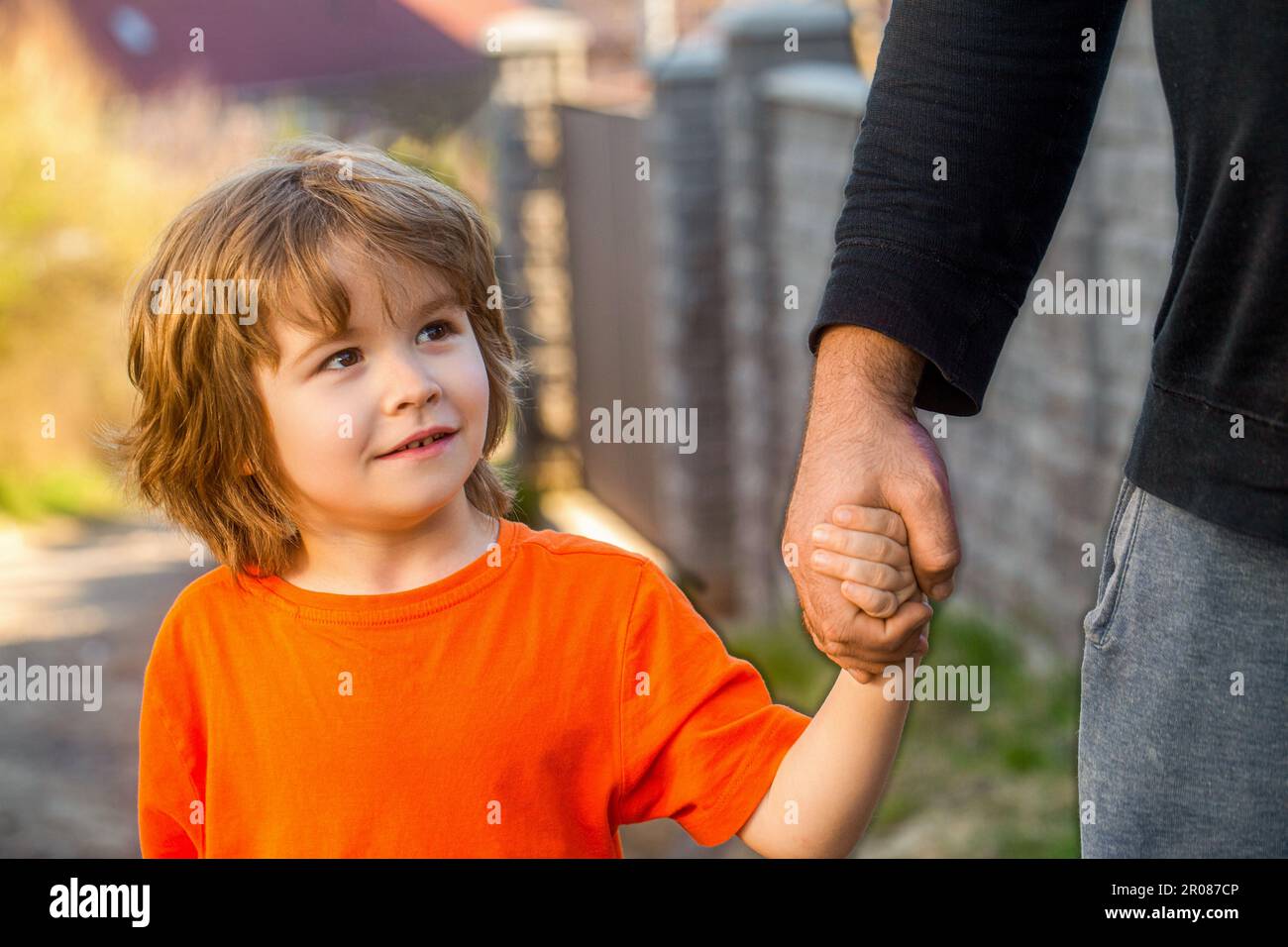 Child hand father. Hands of parent and child outdoors. Parent holds the ...