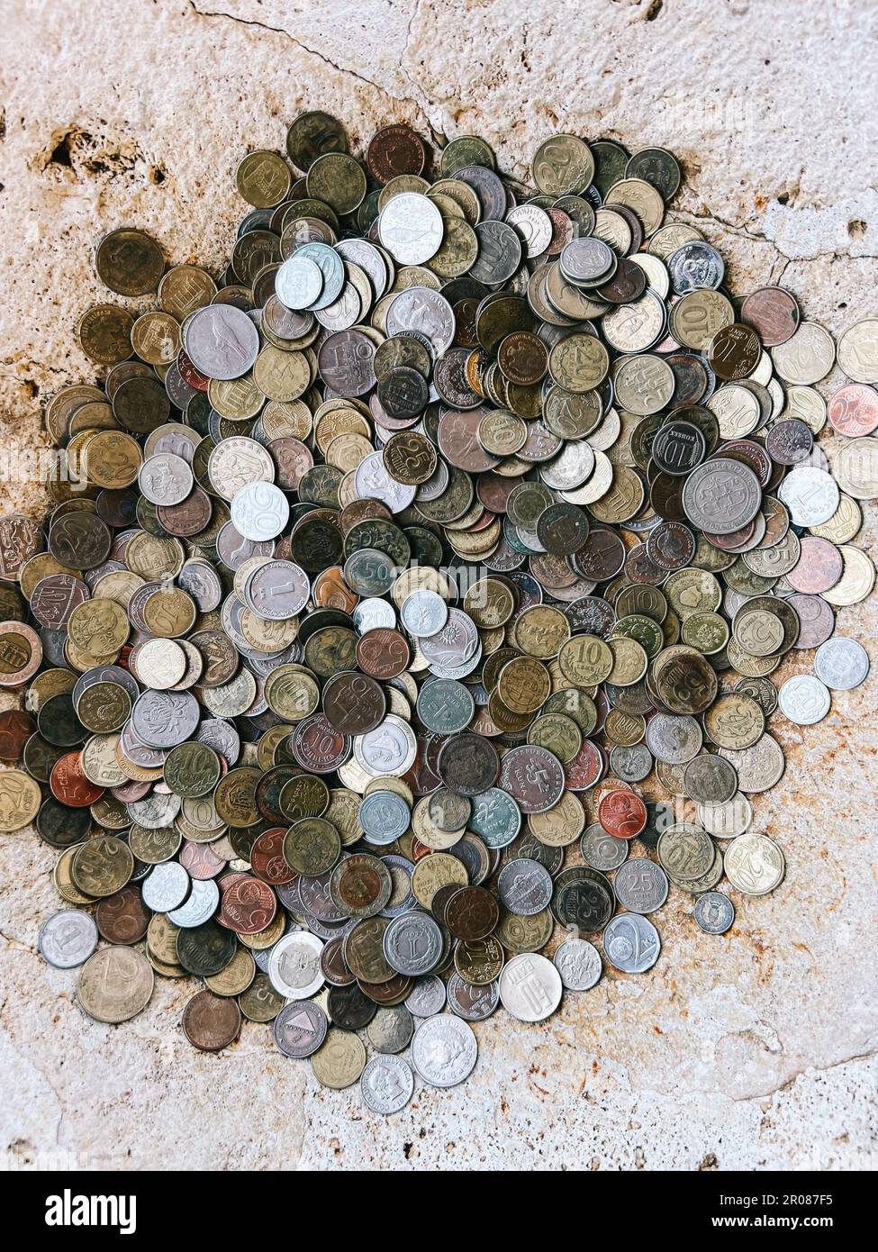 Small coins of different denominations lie on a stone Stock Photo - Alamy