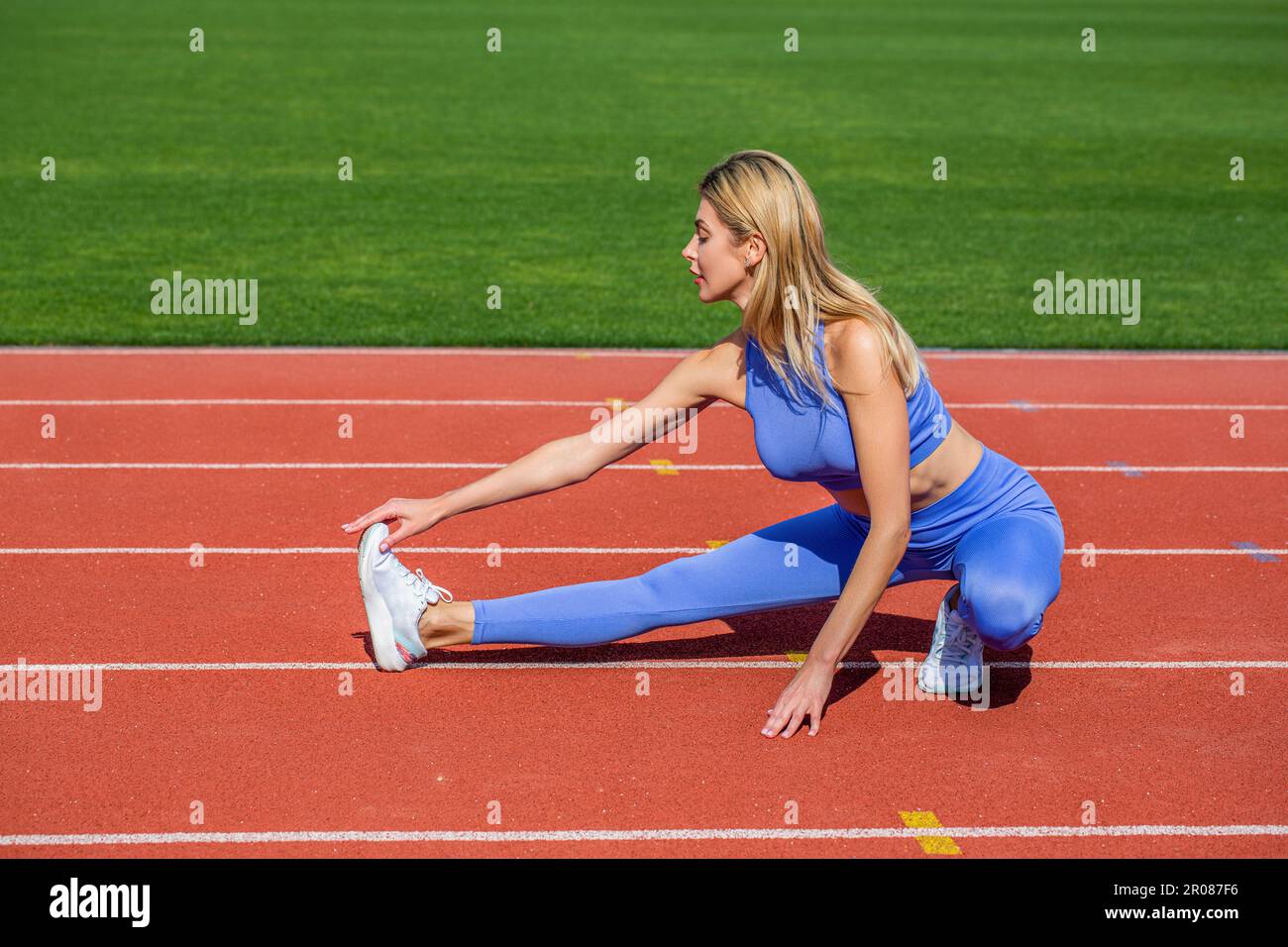 Female runner stretching before workout. Sports exercises and ...
