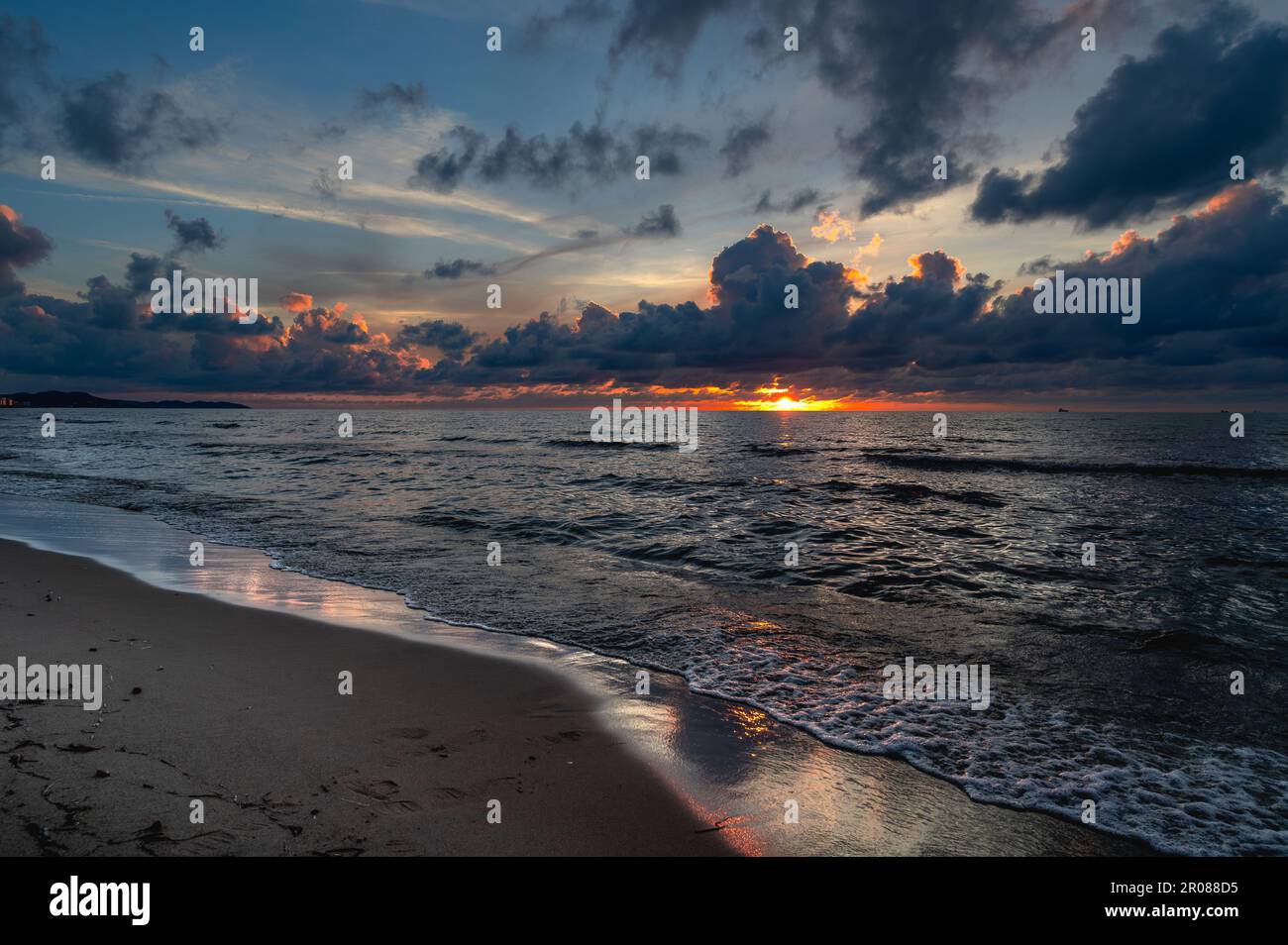 sunset on a sandy beach with dramatic cloudy sky in Golem, Durres ...