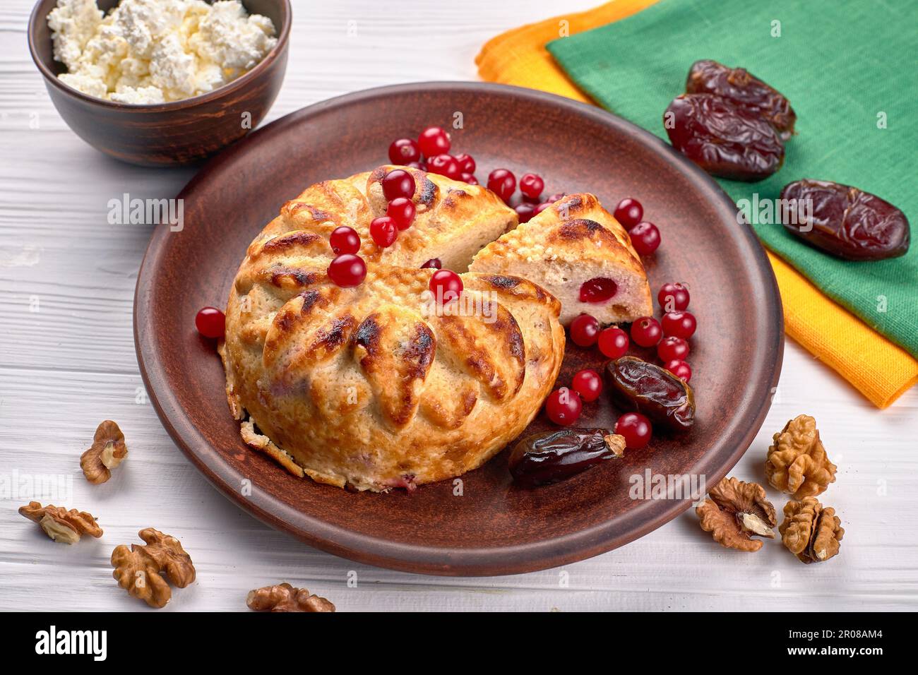 Baked cottage cheese pudding with cranberries, nuts, and dates Stock ...