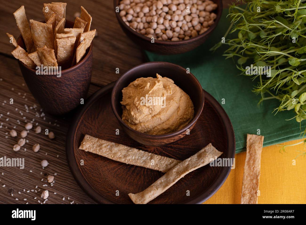 Savory hummus with crispy breadsticks and garnish Stock Photo - Alamy