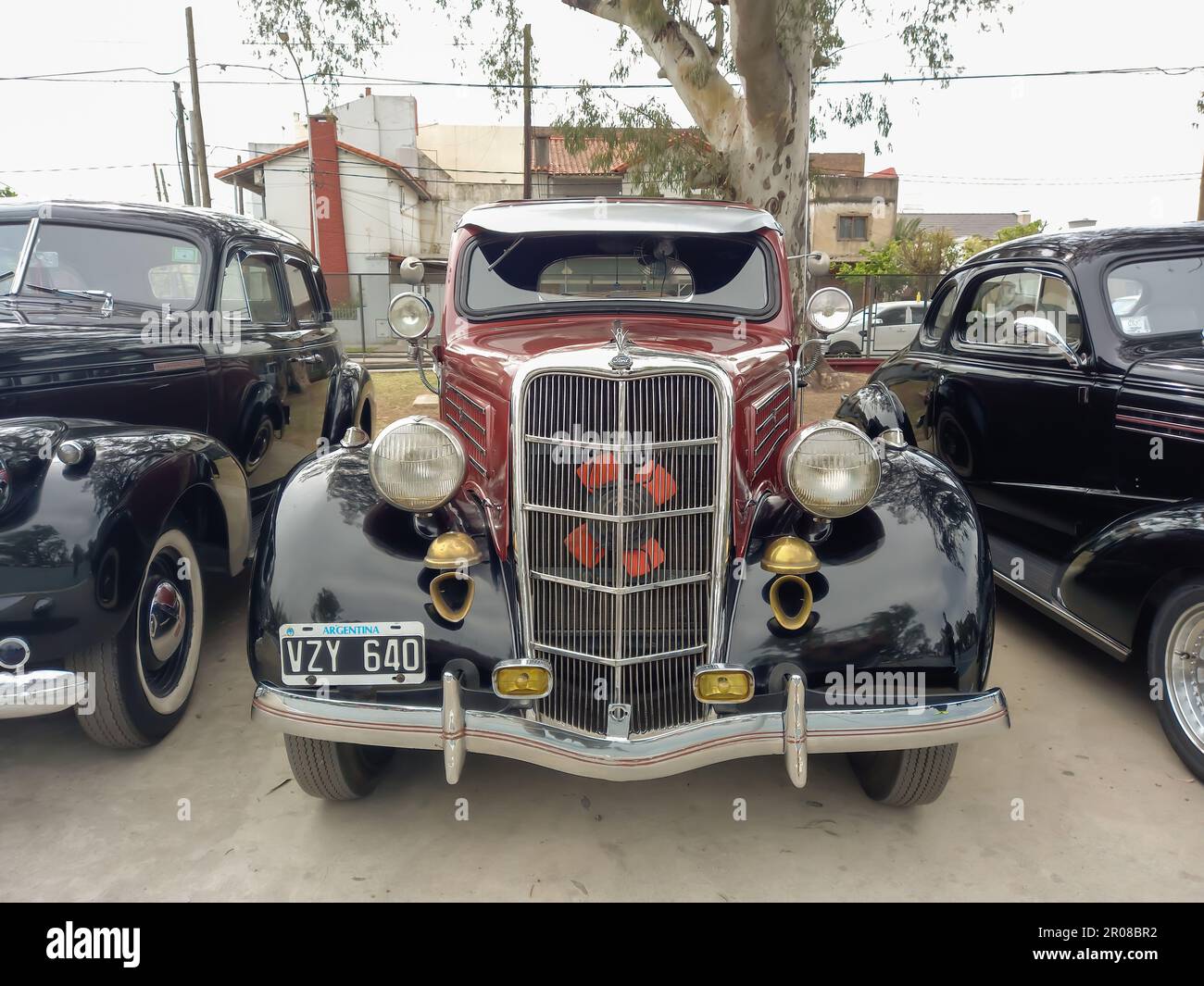Old antique red maroon 1935 Ford 48 V8 coupe five windows flathead in a ...
