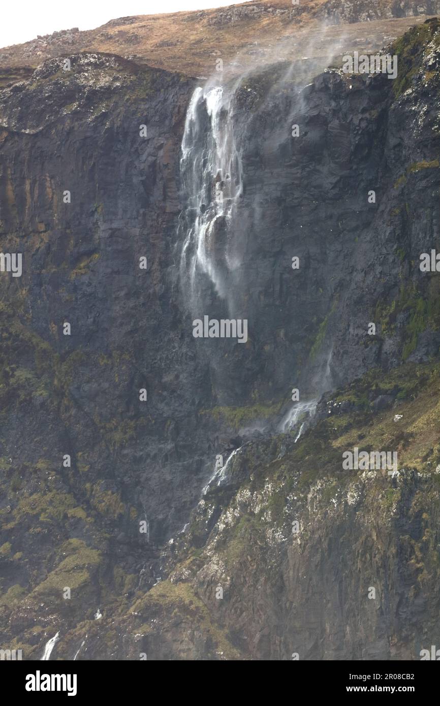 Waterfall being blown back up Cliff during a Storm. Talisker Bay, Isle ...