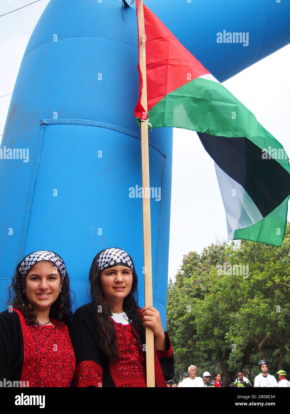Women carrying a Palestinian flag when thousands of people participate ...