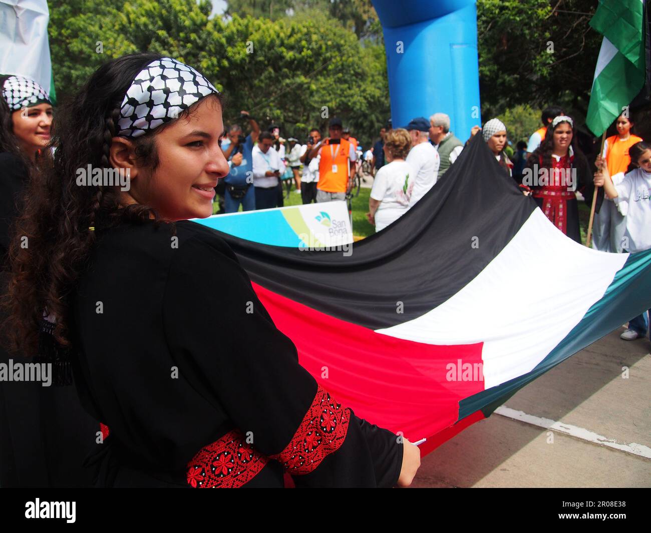 Women carrying a Palestinian flag when thousands of people participate ...