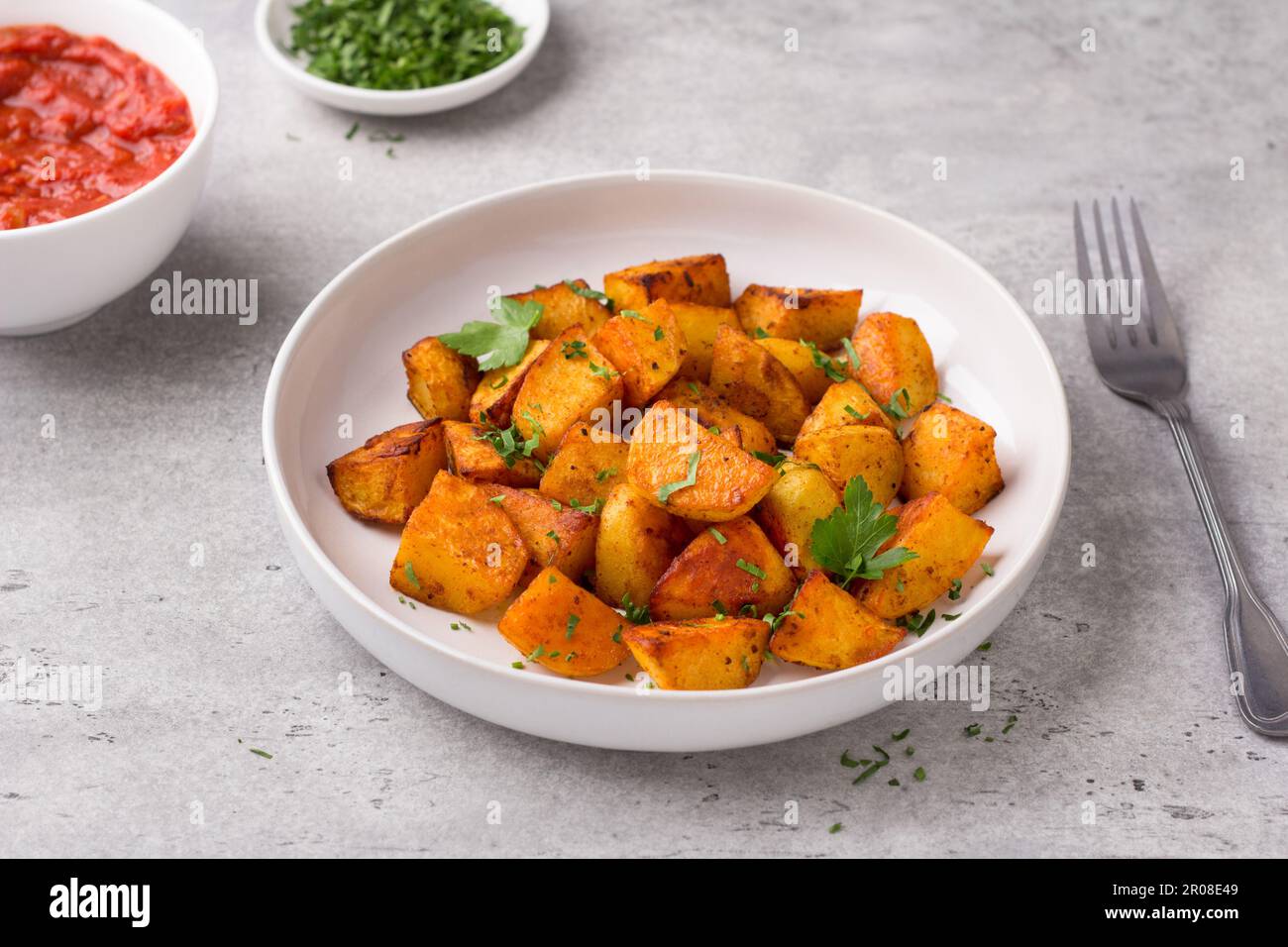 Traditional Spanish potato, patatas bravas with smoked paprika, spicy ...