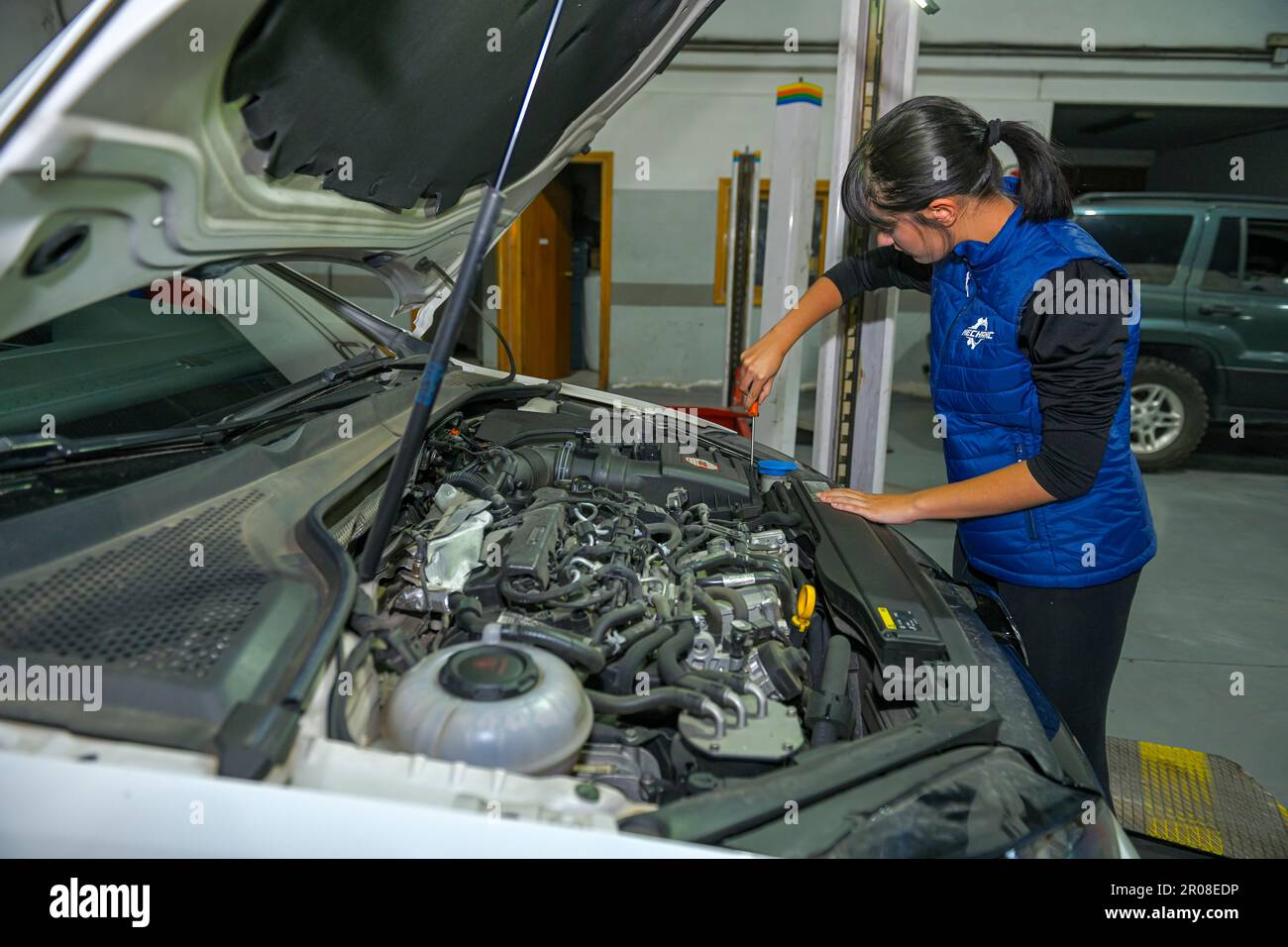 Young female mechanic, working on the repair of a car engine Stock ...