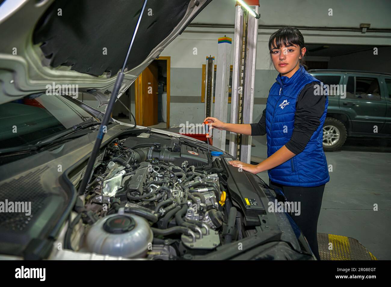 Young female mechanic, working on the repair of a car engine Stock ...