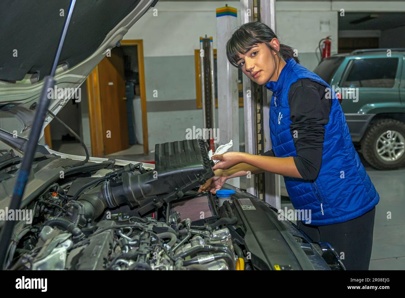 Young female mechanic, working on the repair of a car engine Stock ...