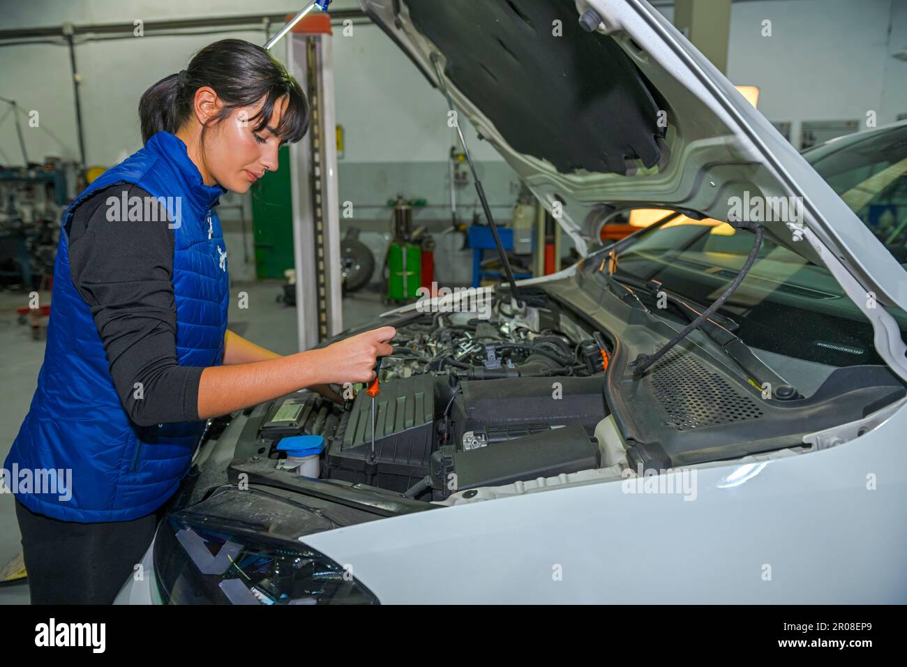 Young female mechanic, working on the repair of a car engine Stock ...