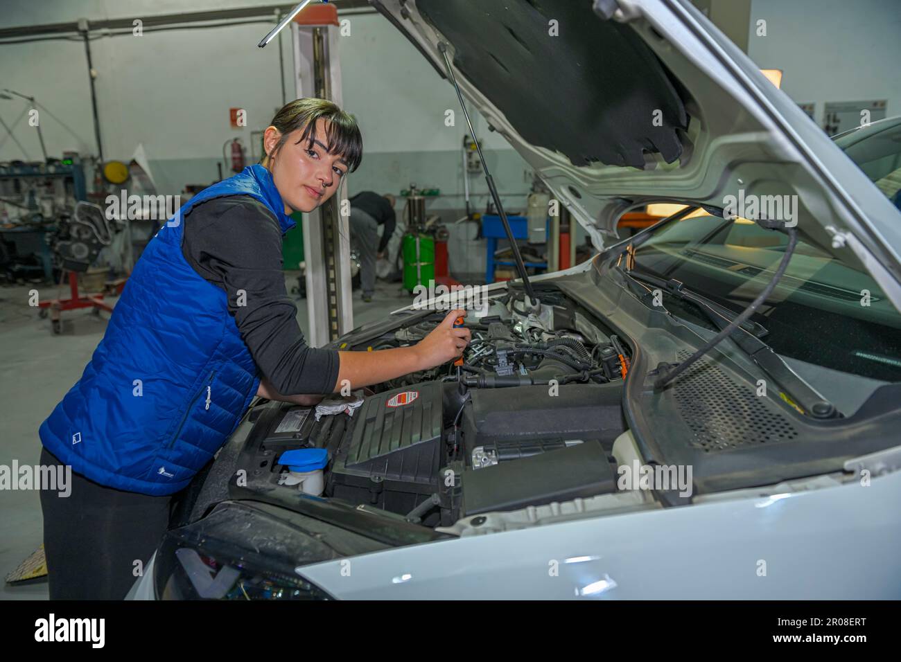 Young female mechanic, working on the repair of a car engine Stock ...